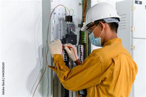 Electrician Engineer Using Digital Multimeter Test Current Electric In Control Panel For Testing