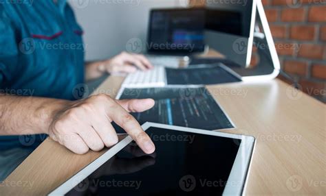 Software Developer Is Pointing To The Paper Working And Analyzing