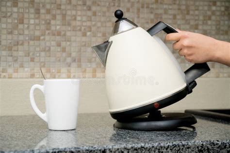 The Woman S Hand Holds Electric Glass Kettle On A Domestic Kitchen Stock Image Image Of Quick