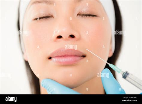 Woman Receiving Botox Injection On Her Lips Stock Photo Alamy
