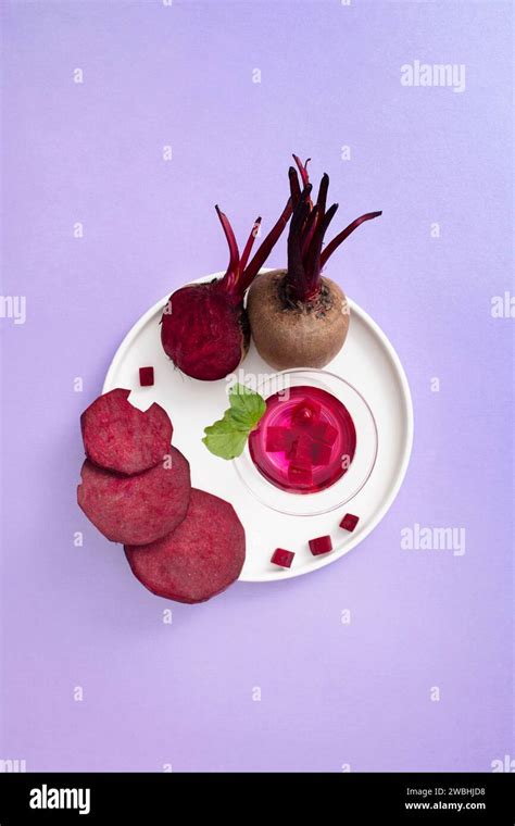 Top View Of Round Shaped Dish Containing Beetroot Slices And A Cocktail Glass Filled With