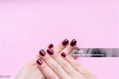아름다운 매니큐어와 여성의 손 복사 공간핑크 배경에 어두운 빨간색 반짝이 손톱 네일 살롱에 대한 스톡 사진 및 기타 이미지 네일 살롱 디자인 매니큐어 미용술 Istock