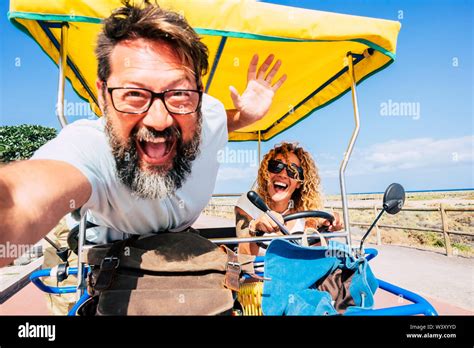 Crazy People Happy Couple Have Fun On Vacation Driving Together A Bike