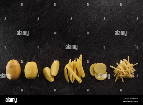 Different Cuts Of Potatoes On A Black Textured Background Photo Taken From Above Stock Photo