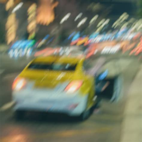 Abstract Blurred Evening Traffic Close Up Of Stopped Yellow Taxi
