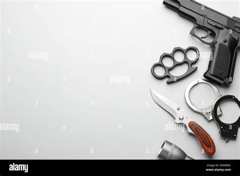 Flat Lay Composition With Black Brass Knuckles On White Background