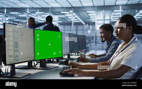Technician Using Isolated Screen Computer Working In Server Farm To