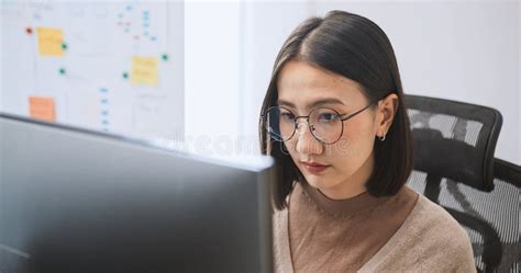 Asian Female Software Developer Coding Program On Desktop Computer