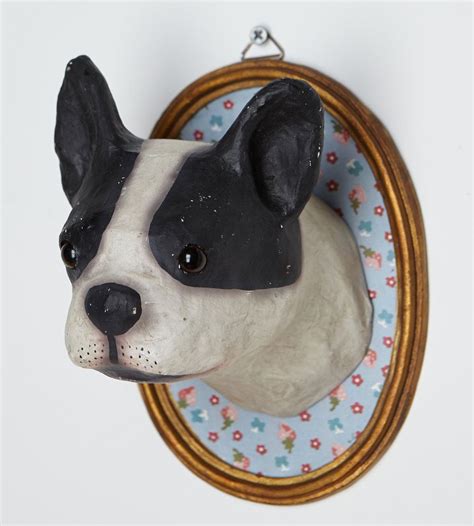 A Ceramic Dog Ornament Hanging On A Wall