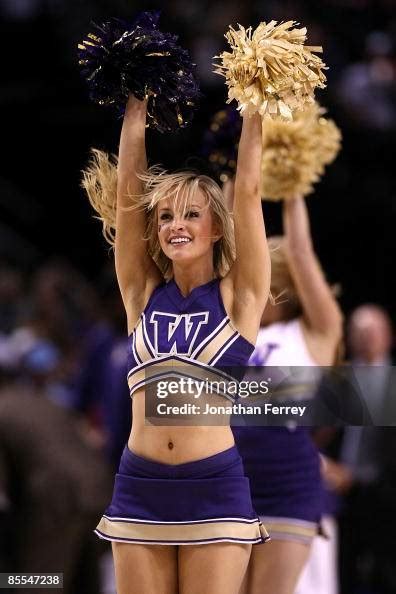 A Washington Huskies Cheerleader Performs During A Break In The