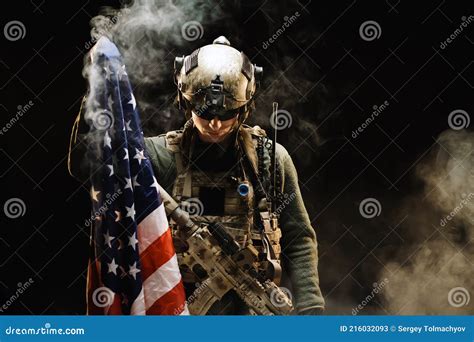 Special Forces Soldier Holding Us National Flag In The Dark Stock Image