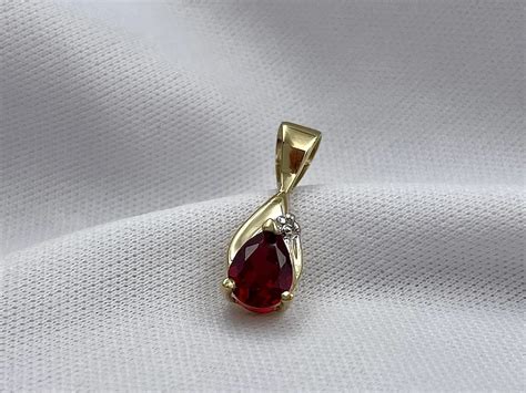 Synthetic Ruby Pendant With Diamond Accent In 10k And 14k Yellow Gold