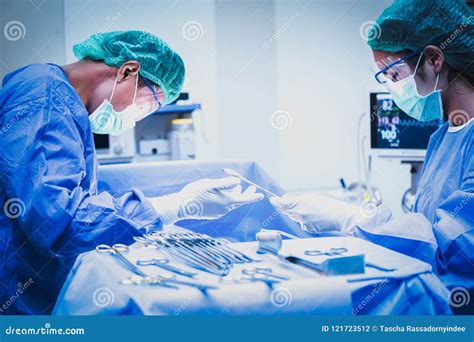 The Surgeon And Assistant Are Operating In The Operating Room Stock