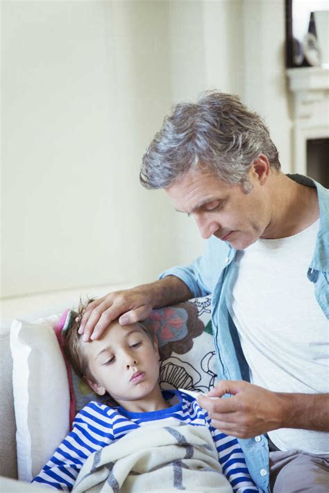 Father Checking Son S Temperature Stock Photo