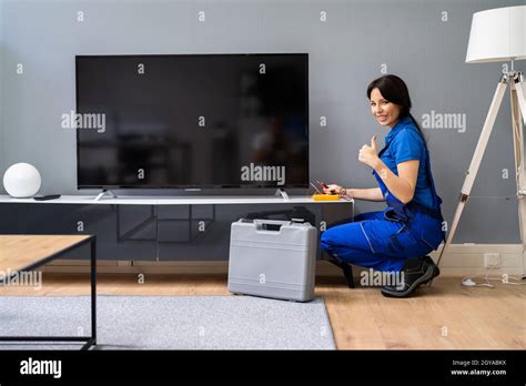 Electrician Repairing Television Or TV Appliance Fixing Screen Stock