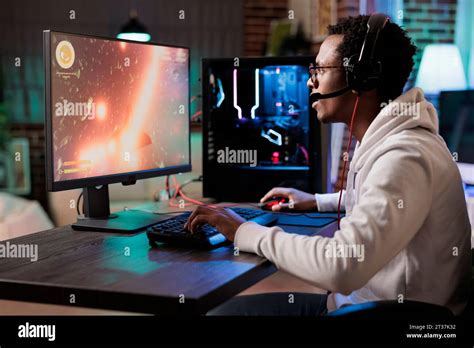 Gamer Playing Classic Arcade Spaceship Racing Videogame Doing Flying Maneuvres Through Asteroid