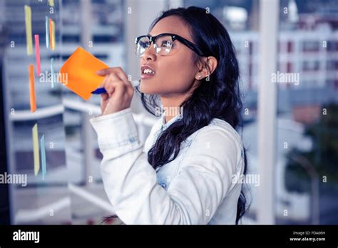 Asian Woman Removing Sticky Note Stock Photo Alamy