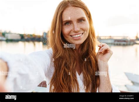 Image Of Happy Ginger Woman Smiling And Taking Selfie Photo While
