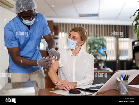 Young Female Office Employee In Protective Face Mask Getting Antiviral