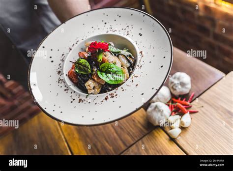 Unrecognizable Waiter Serving Shrimp Dish Black Tagliolini Pasta With