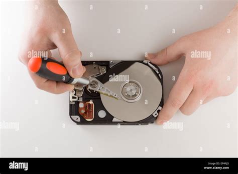 The Computer Hard Drive In The Course Of Dismantling On A White Background Stock Photo Alamy