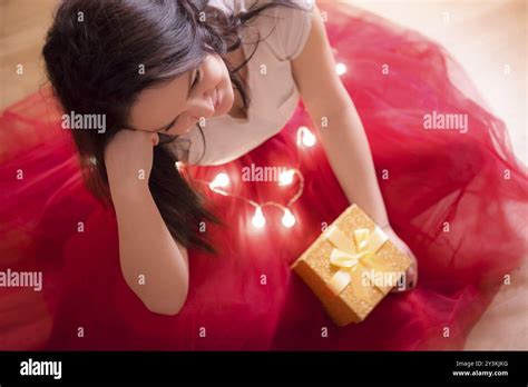 Beautiful Young Brunette Woman Dressed In A Red Tutu Sitting On The