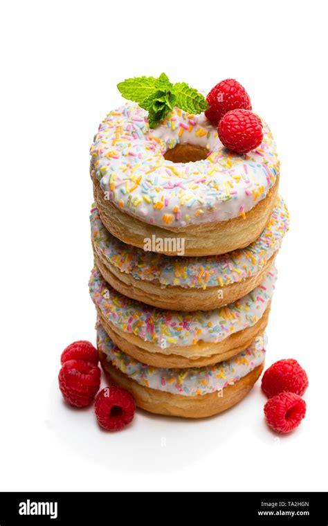 Pink Doughnuts With Sprinkles And Fresh Raspberry Isolated On White