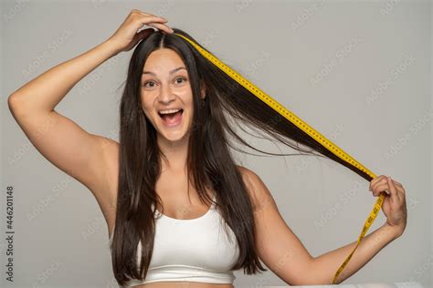 A Babe Happy Woman Shows The Length Of Her Hair With A Measuring Tape Stock Photo Adobe Stock