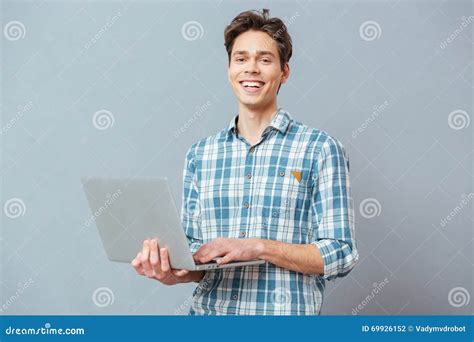 Laughing Man Standing With Laptop Computer Stock Photo Image Of Communication Lifestyle 69926152