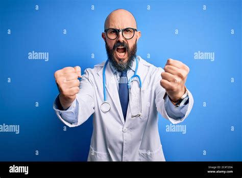Handsome Bald Doctor Man With Beard Wearing Glasses And Stethoscope