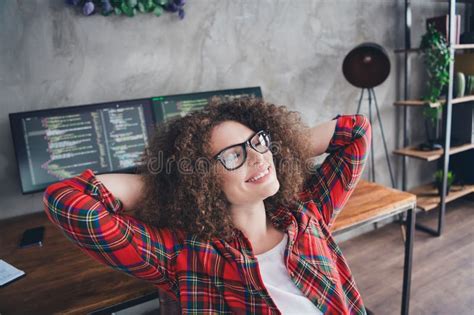 Young Woman Programmer In A Casual Workspace Smiling And Relaxing