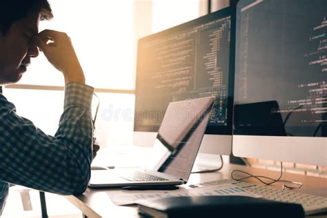 Man Programmers Are Stressed And Hand Holding Nose With Headache At The