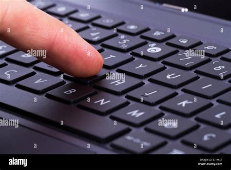 Index Finger Pressing Key On Laptop Keyboard Stock Photo Alamy