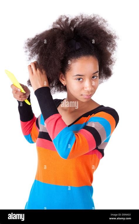 Black African American Teenage Girl Combing Her Afro Hair Isolated On
