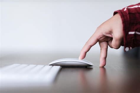 premium photo cropped hand of person gesturing by computer mouse