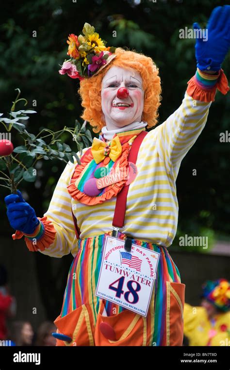A Colorful Clown Waves To The Crowd Of Spectators During The Annual 4th