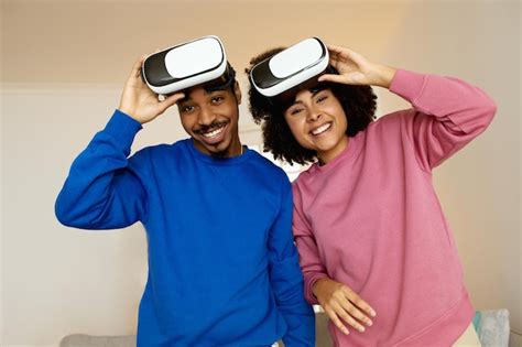 Premium Photo Happy Black Spouses Posing With Vr Glasses At Home