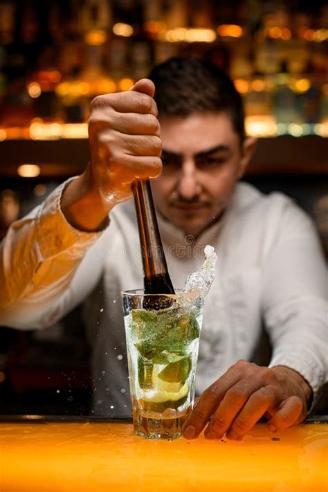 Bartender Prepares Cocktail Mojito Using The Madler Glass With Mint