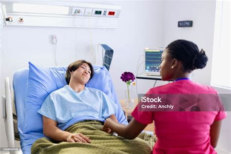 Caring Nurse Comforting Heart Disease Patient In The Hospital Stock