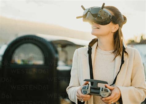 Positive Anonymous Female In Modern Black Vr Headset With Remote