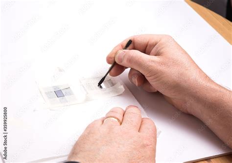 Man Applying Liquid Metal To The Back Of A Cpu Computer Processor Unit Connector For Better