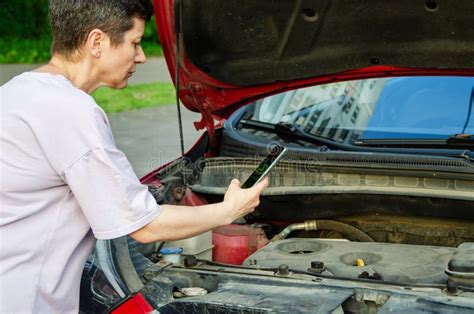 Woman Photographs Breakdown In The Open Hood Of A Car Stock Image Image Of Holding Accident