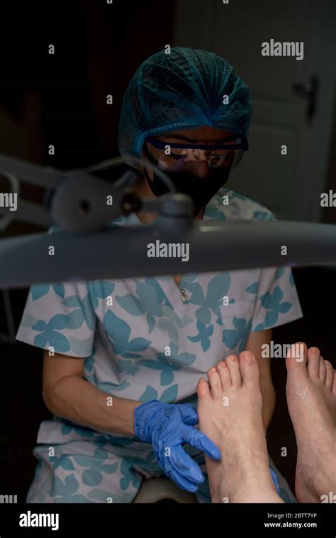 Pedicure In The Beauty Salon The Beautician Cuts The Skin With Fingernails And Performs