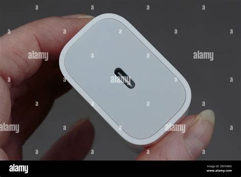 Close Up Macro Shot Of A USB C Watt Power Adapter Showing The USB C Port Side Being Held By A