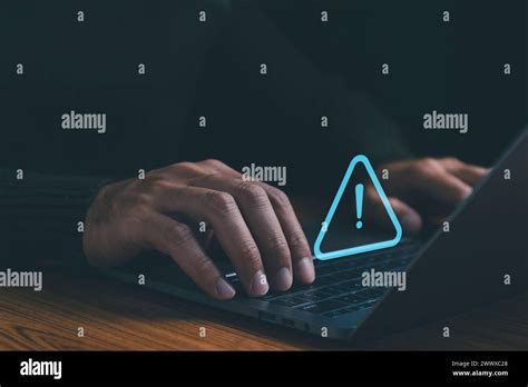businessman using laptop computer with alerts warning triangles