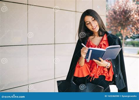 Brunette Woman Writing In Her Blue Notebook Stock Photo Image Of Employment Confident 163246598