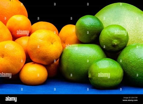 Isolated Orange And Green Color Groups Citruses Fruits On Black