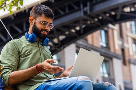 Portrait Indian Student Programmer Using Laptop Computer In Park Stock