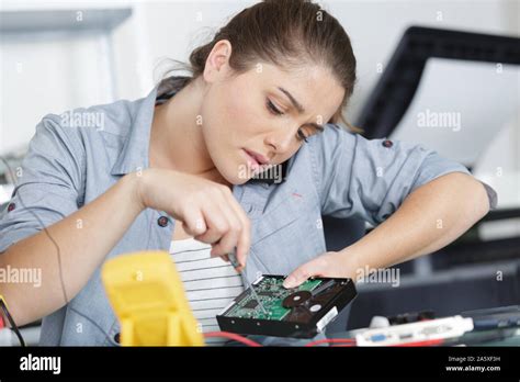 Woman Fixing A Computer Hard Drive Stock Photo Alamy