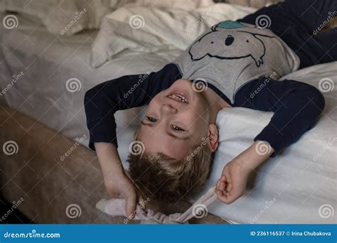 Little Boy Smiling Lying On His Back On The Bed Stock Image Image Of